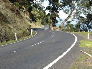 What is superelevation in road design?